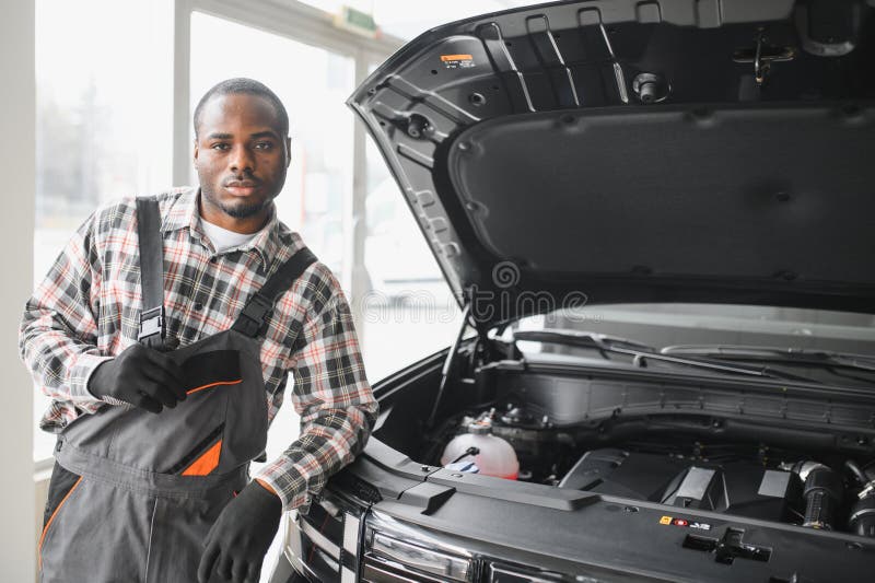 Auto Mechanic Performing a Routine Service Inspection in a Service ...
