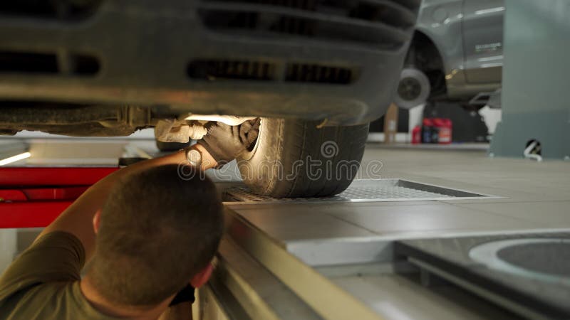 Auto Mechanic Performs Hydraulic Play Detection on Car Suspension ...