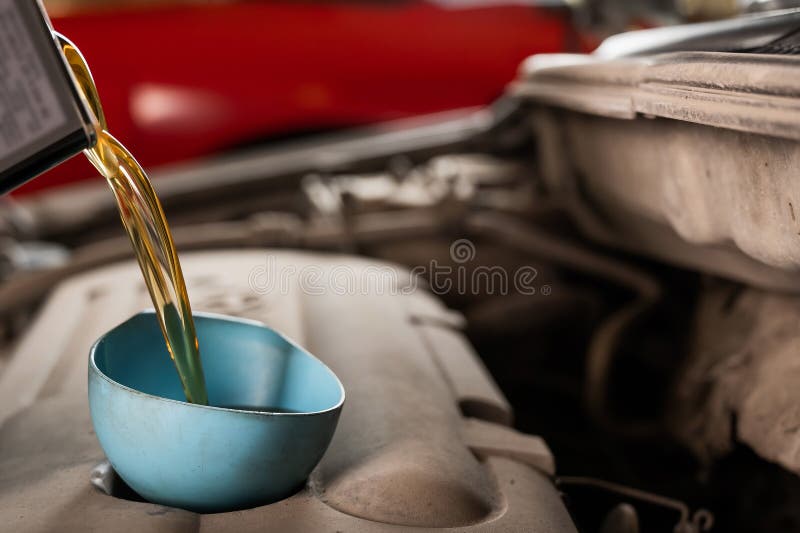 Auto Mechanic Pours Oil into a Car Engine. Stock Image - Image of ...