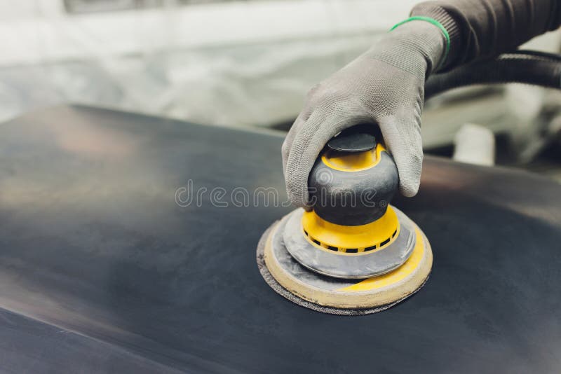 Auto Mechanic Preparing the Car for Paint Job by Applying Polish with ...