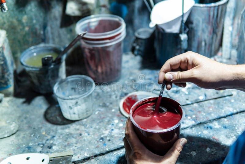 Auto Mechanic Preparing Red Car Paint in a Workshop. Stock Image ...
