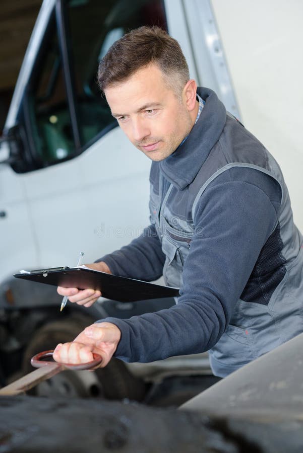 Auto Mechanic Repairing Vehicle Inside Workshop Stock Photo - Image of ...