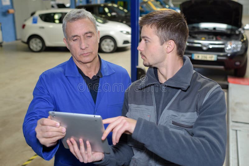 Auto Mechanic Teacher and Trainee Performing Tests at Mechanic School ...