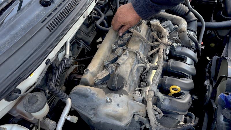 Auto Mechanic Testing and Checking Ignition Coils of a Car Engine Stock ...