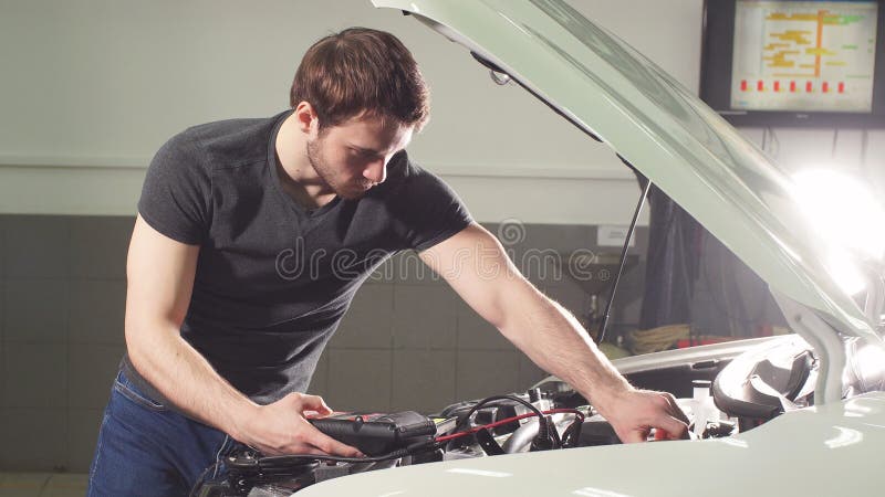 Auto Mechanic Testing Electrical System on Automobile. Stock Photo ...