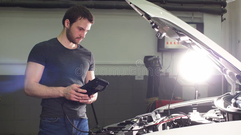 Auto Mechanic Testing Electrical System on Automobile. Stock Image ...