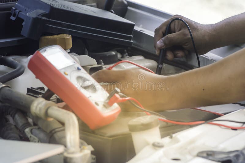 Auto Mechanic Uses a Multimeter Voltmeter. Stock Image - Image of ...