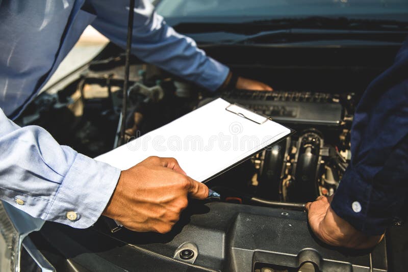 Auto Mechanic Using Checklist for Car Engine Systems after Fixed. Stock ...