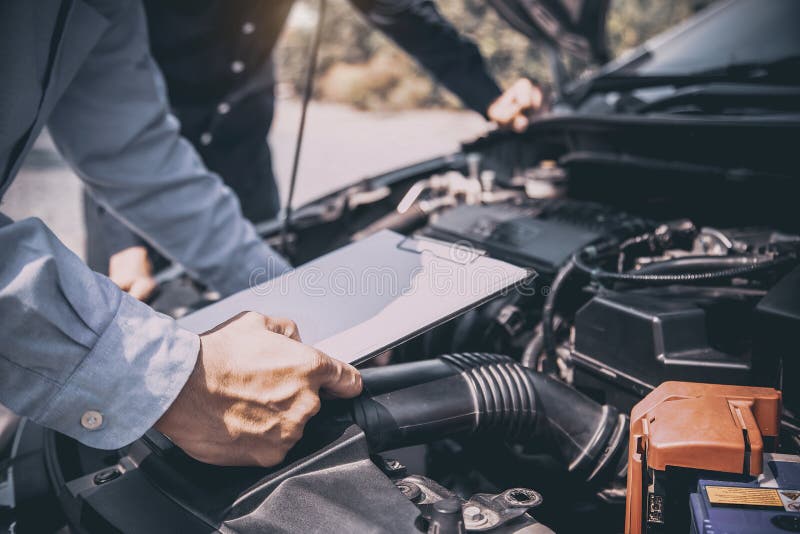 Auto Mechanic Using Checklist for Car Engine Systems after Fixed. Stock ...