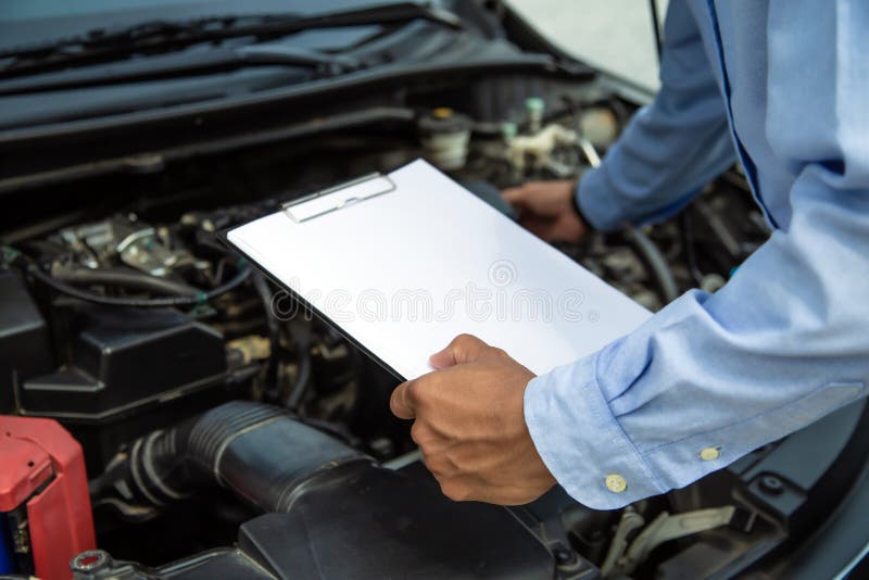 Auto Mechanic Using Checklist for Car Engine Systems after Fixed. Stock ...