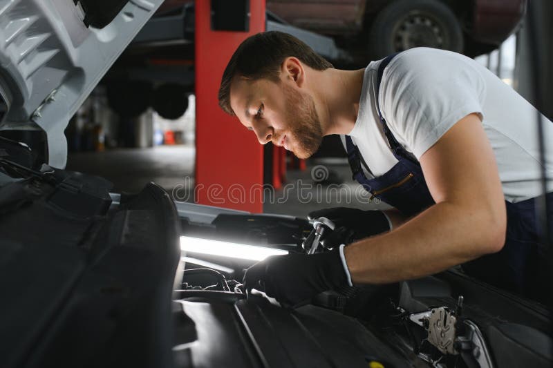 Auto Mechanic Working on Car Engine in Mechanics Garage. Repair Service ...