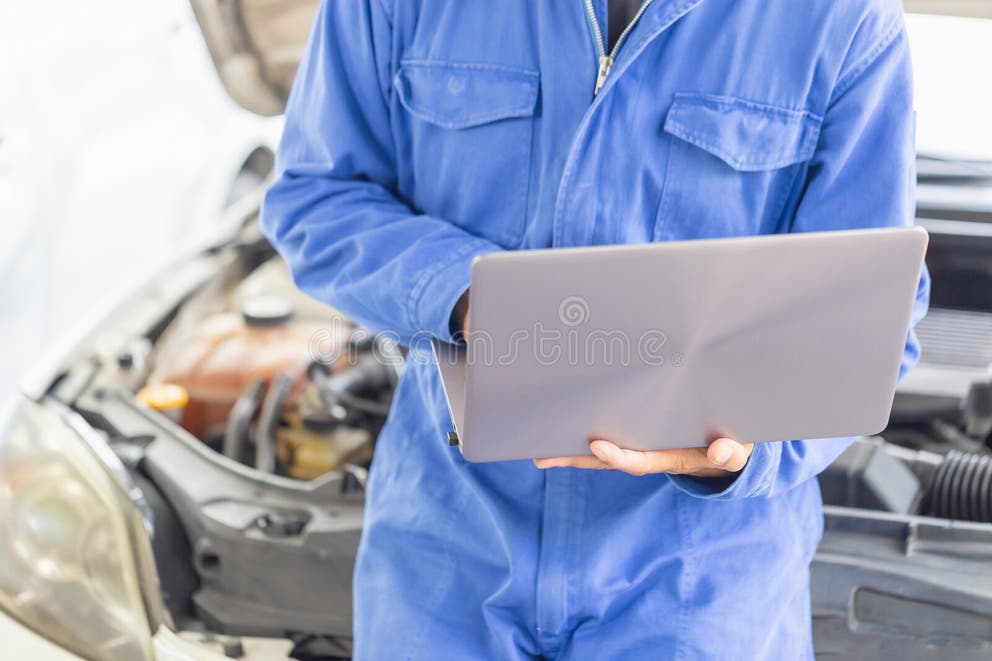 Auto Mechanic Working on Laptop at Mechanic Shop, Technician Diagnosing ...
