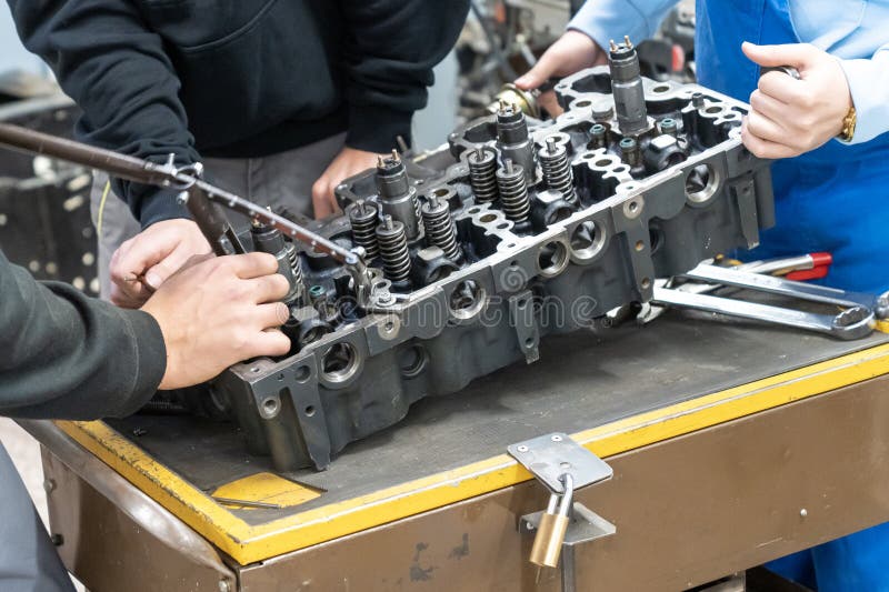 Auto Mechanics Assembling a Disassembled Car Engine in a Workshop Stock ...