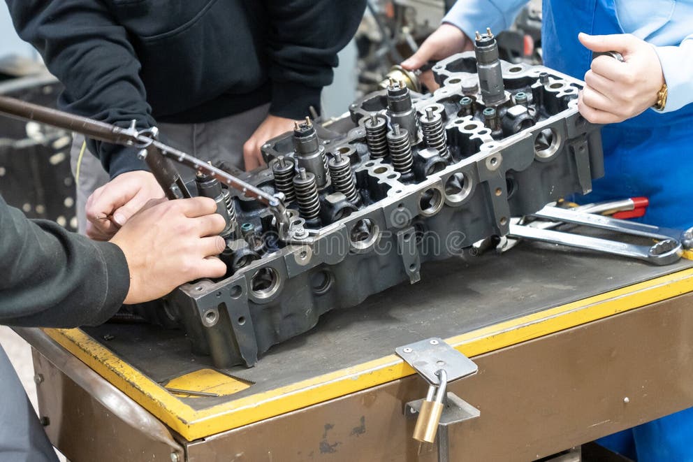 Auto Mechanics Assembling a Disassembled Car Engine in a Workshop Stock ...