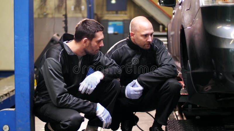 Auto Mechanics in Uniform Install Gearbox, Repair Car Clutch in Modern ...