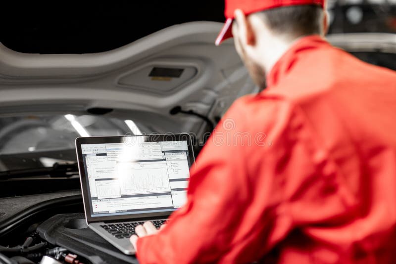 Auto Mechanics Doing Diagnostics with Laptop Stock Photo - Image of ...