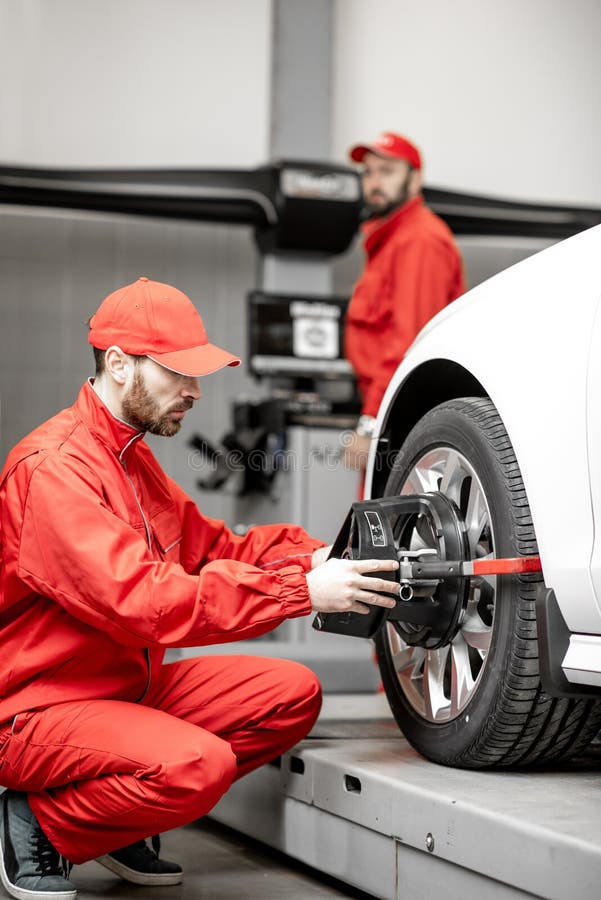Auto Mechanics Making Wheel Alignment at the Car Service Stock Image ...