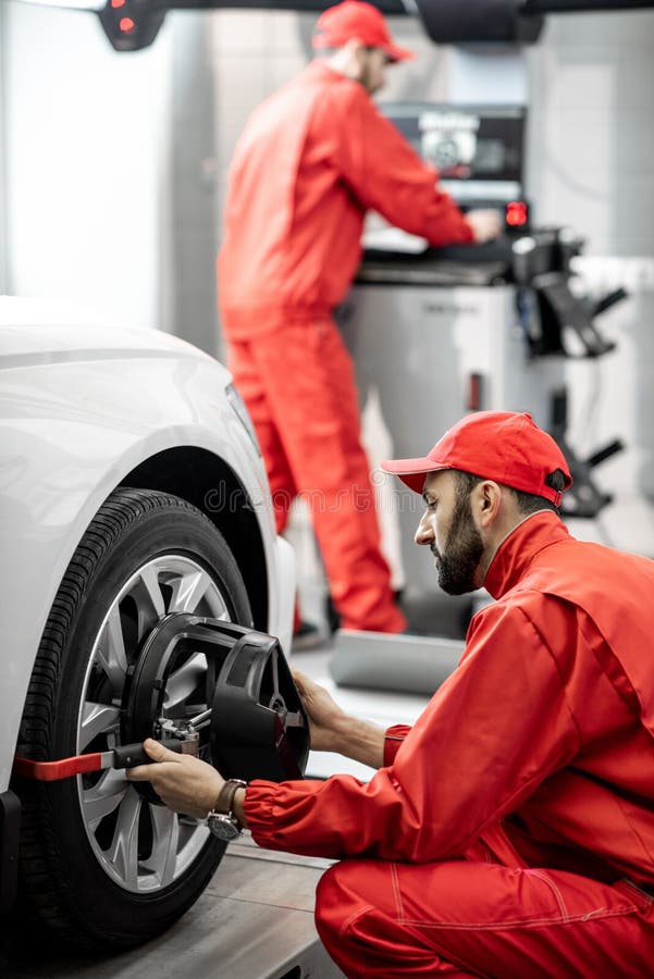 Auto Mechanics Making Wheel Alignment at the Car Service Stock Image ...