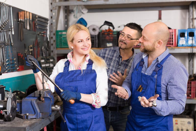 Auto mechanics at workshop stock image. Image of female - 63046235