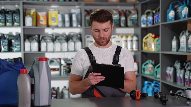 Auto Parts Seller Standing at Counter Checking Car Parts and Making ...