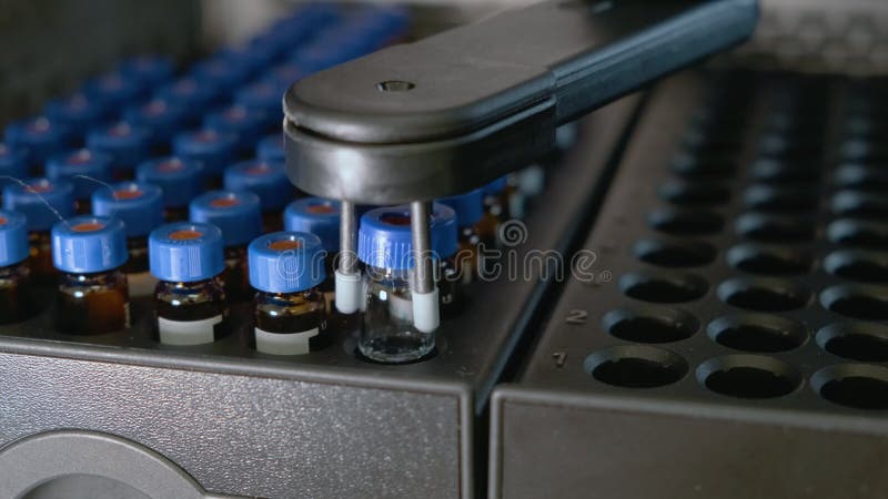 Auto Sampler Takes a Vial and Injects a Sample into High Performance ...