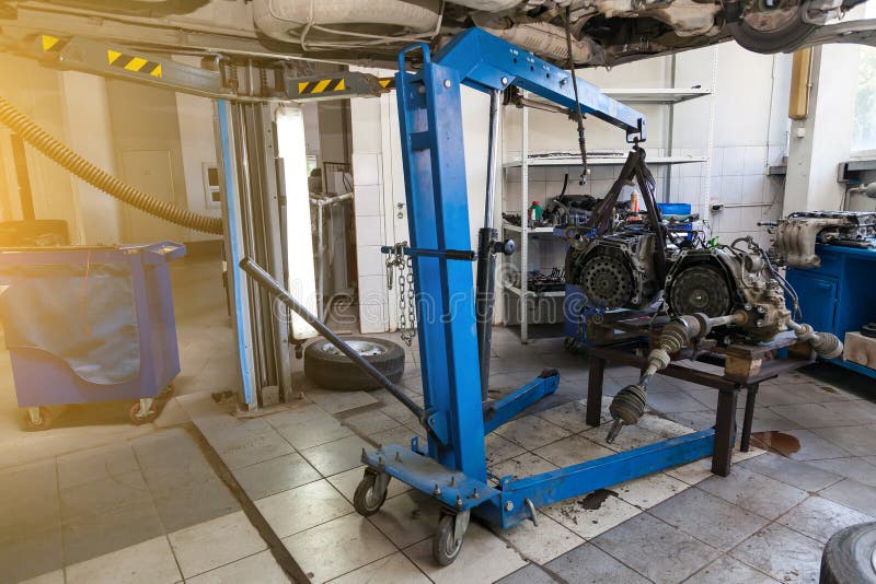 Auto Service with Engine on Blue Crane Under Vehicle Stock Image ...