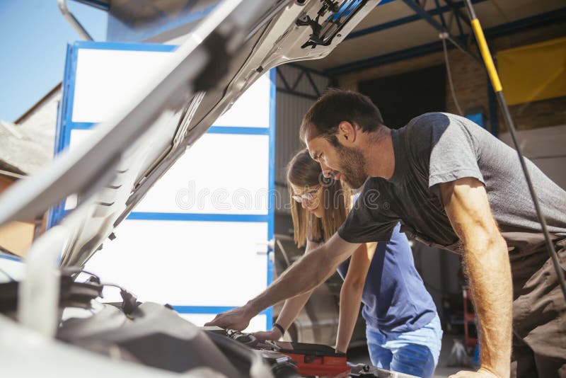 In Auto Service stock photo. Image of male, female, mechanical - 65249878