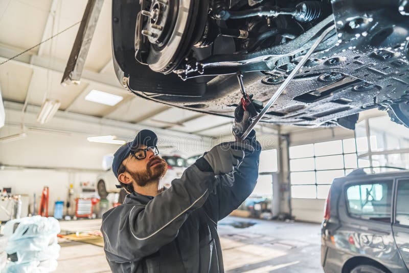 Auto Serviceman Working on a Car Using Special Tools for Chassis ...