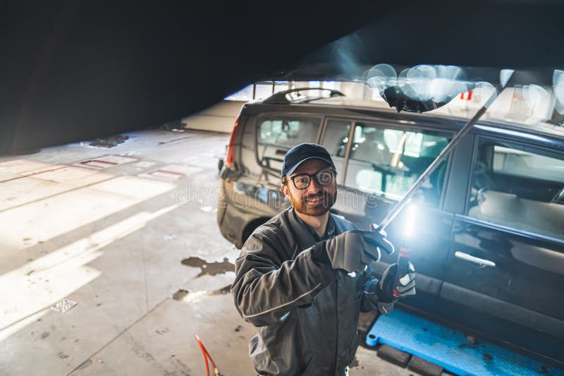 Auto Serviceman Working on a Car Using Special Tools for Chassis ...