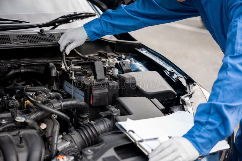 Auto Technician in a Workshop Writing on a Clipboard Checking Car& X27 ...