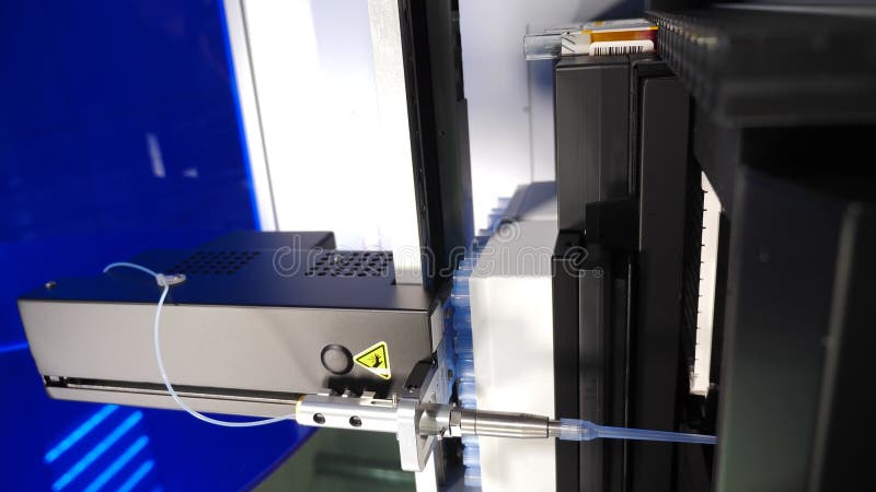Automated Analysis Machine Used at Laboratory. Vertical Footage. Human ...