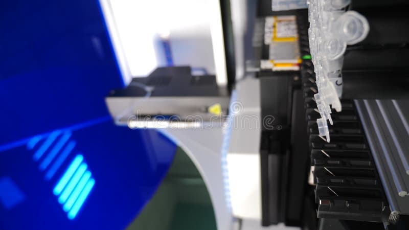 Automated Analysis Machine Used at Laboratory. Vertical Footage. Human ...
