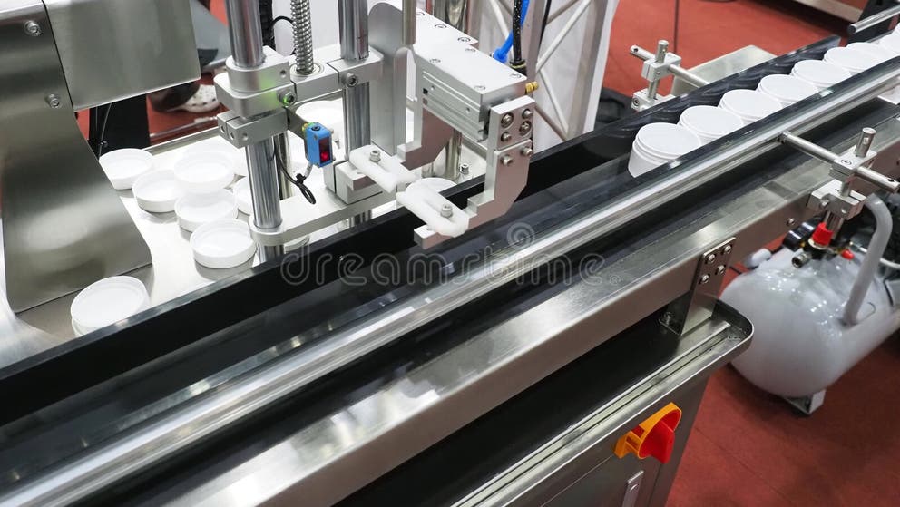 An Automated Capping Machine on a Conveyor Belt and Designed for High ...