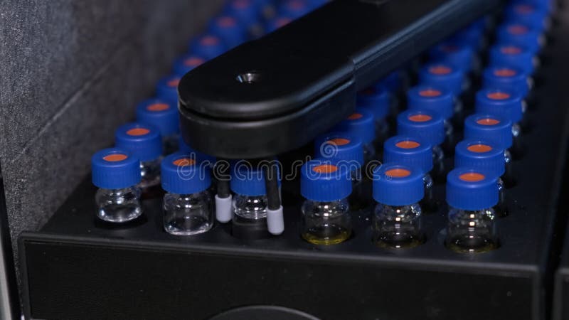 Automated Conveyor Line of Auto Sampler in HPLC System. Vials with Blue ...