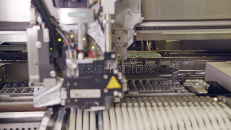 Automated SMT Machine Placing Electronic Components on a Board. Stock ...