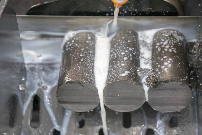 The Automatic Band Saw Machine Cutting the Metal Rod with the Liquid ...