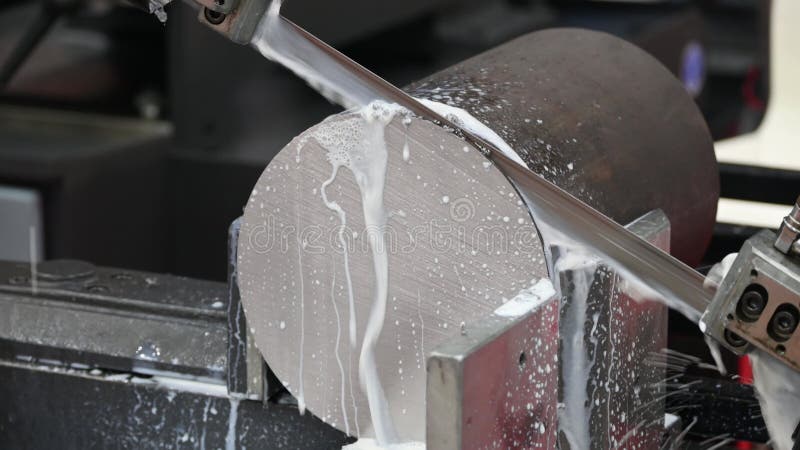The Automatic Band Saw Machine Cutting the Metal Rod with Water Base ...