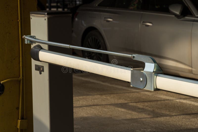 An Automatic Barrier Gate Stands Closed at the Entrance of a Parking ...