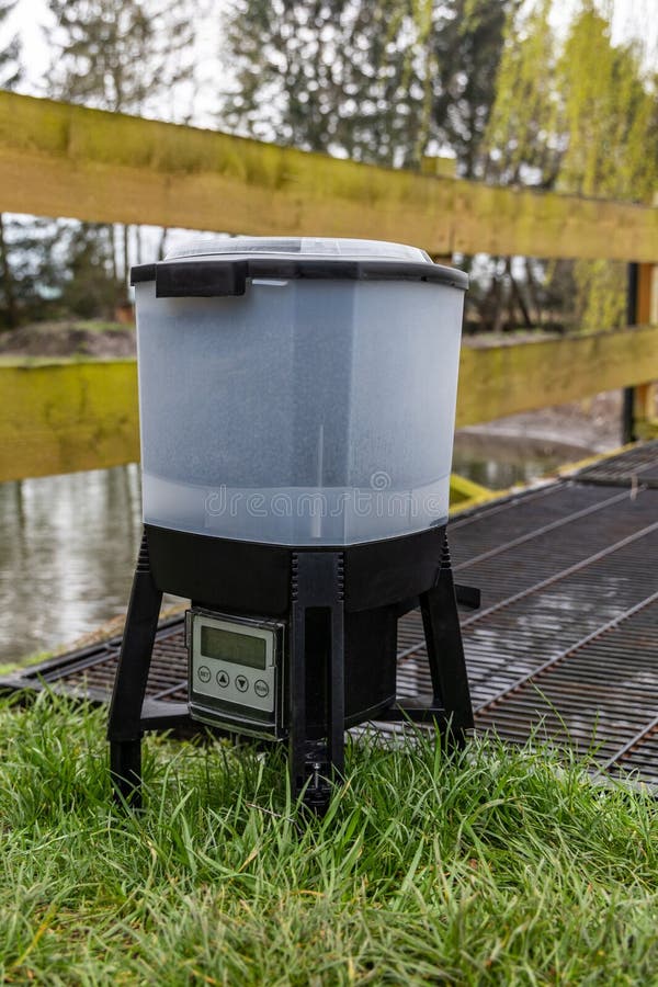 An Automatic Fish Feeder Stands at the Edge of a Trout Pool Stock Image ...