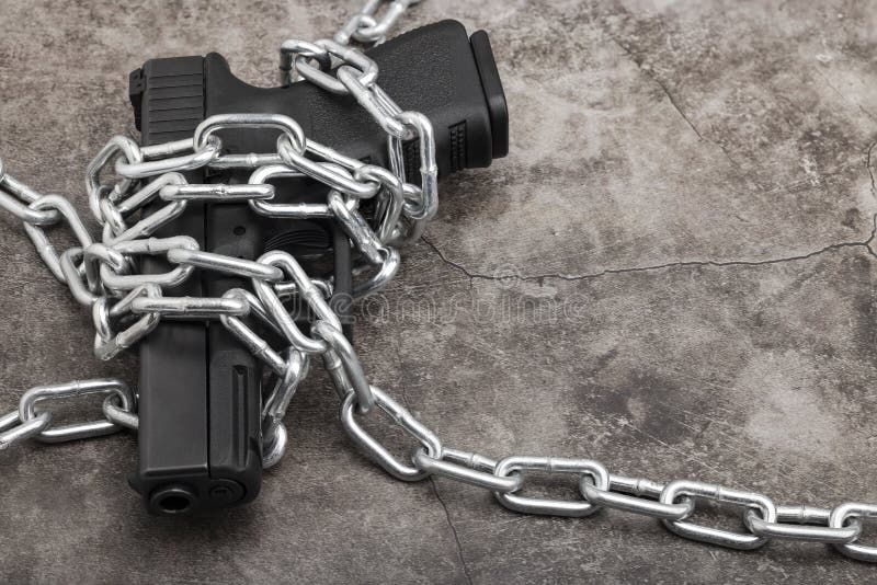 Automatic Hand Gun and Metal Chains on Texture Background , Gun Control ...