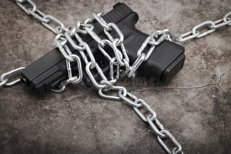 Automatic Hand Gun and Metal Chains on Texture Background , Gun Control ...