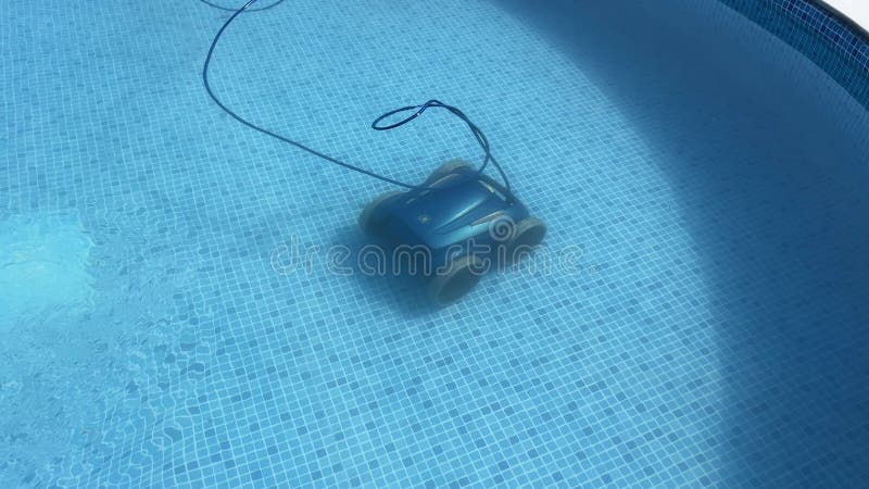 An Automatic Pool Cleaner Operating Underwater in a Clear Blue Swimming ...