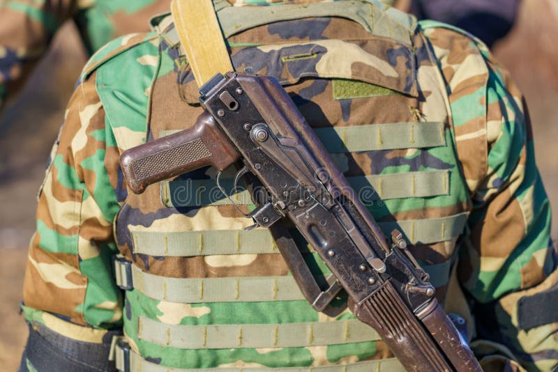 Automatic Rifle without a Magazine on the Back of a Military Man ...