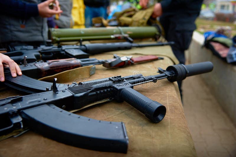 Automatic Rifle with a Silencer on the Table with Weapons. Stock Image ...