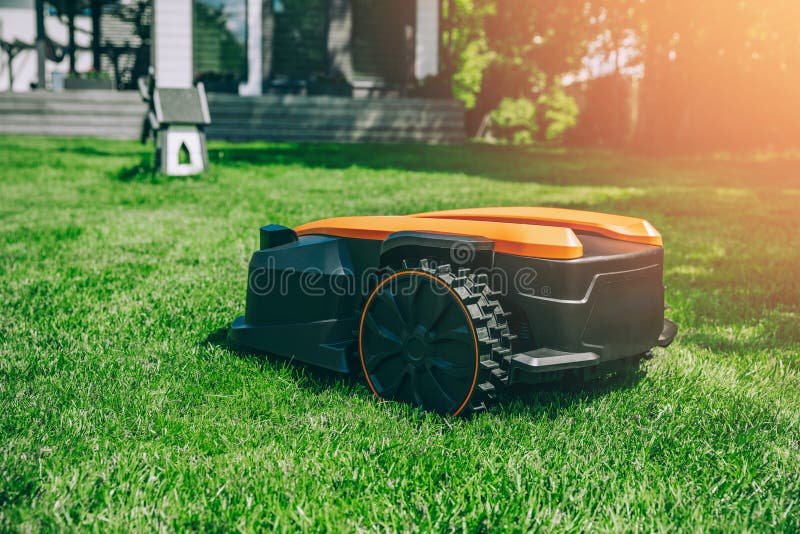 Automatic Robotic Lawn Mower on a Green Lawn Close-up. Grass Lawn Mower ...