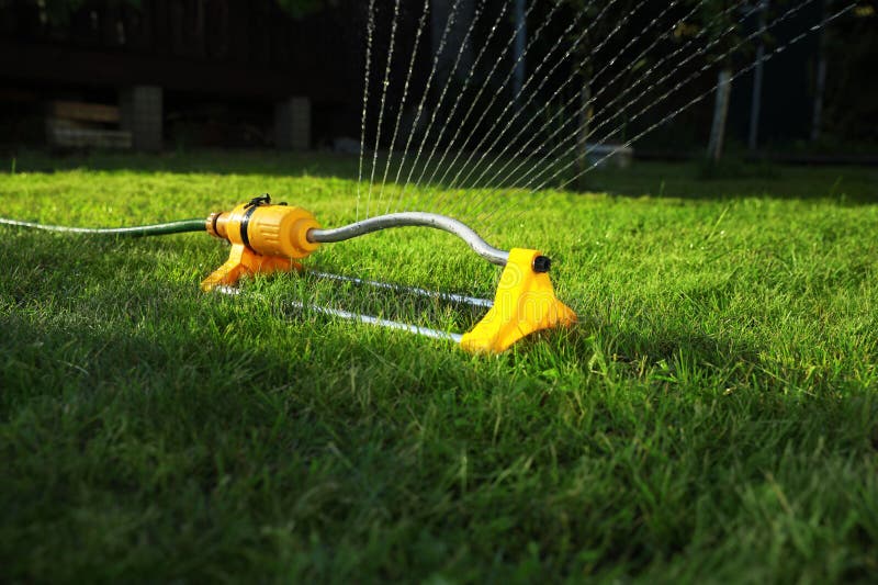Automatic Sprinkler Watering Green Grass on Lawn Outdoors. Irrigation ...