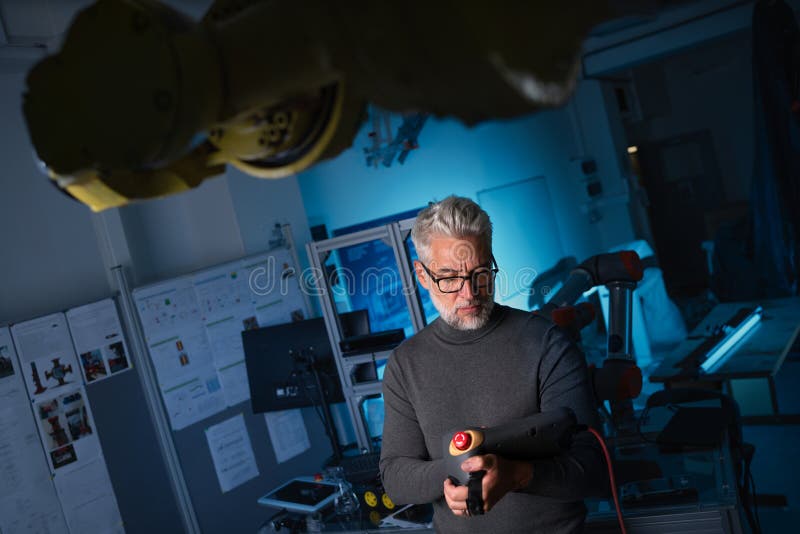 Automation Engineer, Technician Holding Remote Controller of Robotic ...