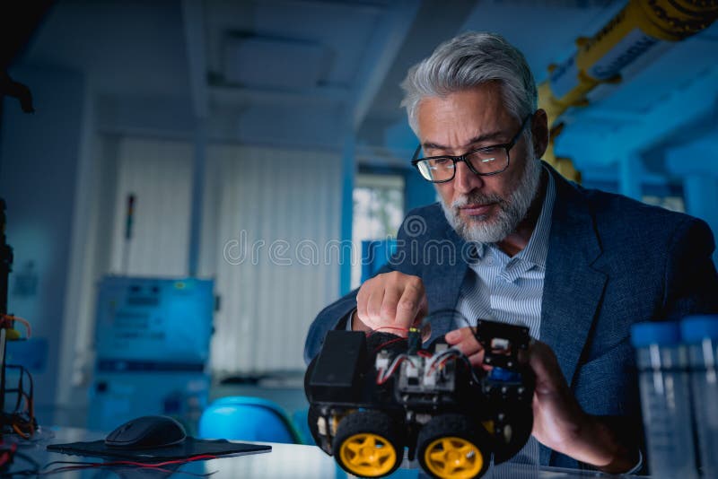 Automation, Robotics Engineer Assembling Robotic Car. Concept of Modern Technology in Industries ...