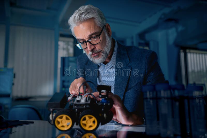 Automation, Robotics Engineer Assembling Robotic Car Prototype for ...