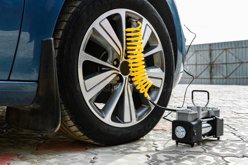 Automobile Compressor Inflating Car Wheel. Stock Image - Image of ...